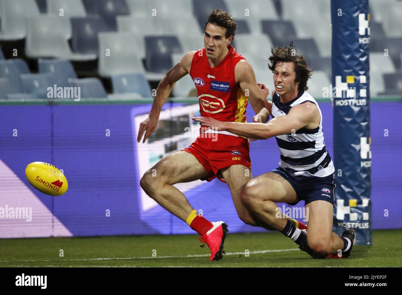 Ben King of the Suns kicks a goal ahead of Jack Henry of the Cats during the Round 5 AFL match ...