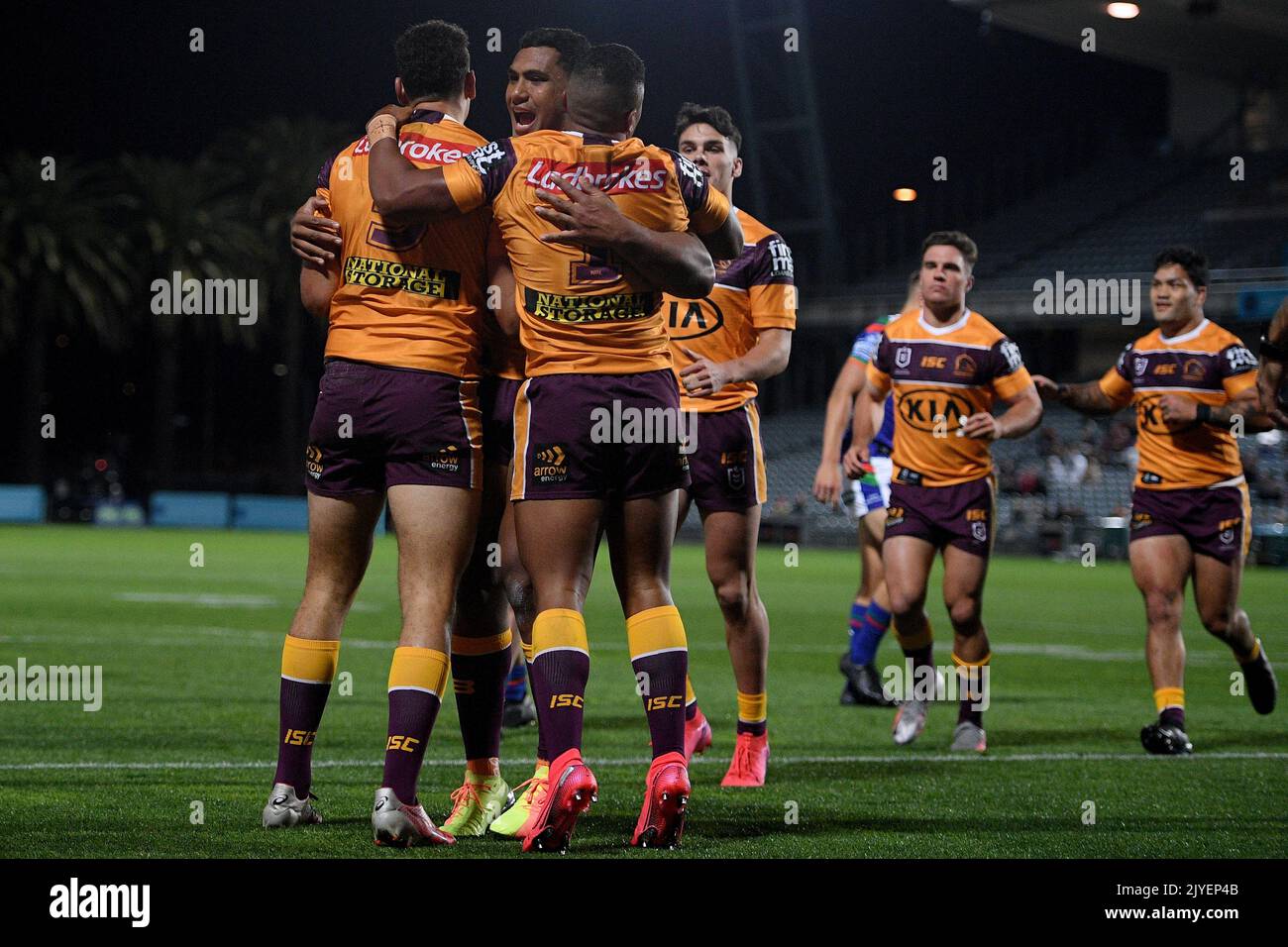 Xavier Coates of the Broncos (left) celebrates with teammates after ...