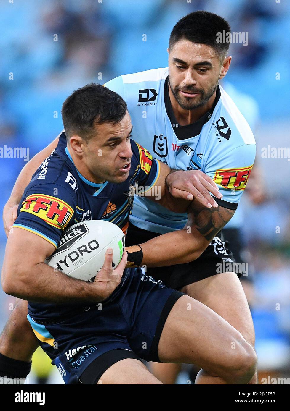 Corey Thompson of the Titans (left) Shaun Johnson of the Sharks is ...