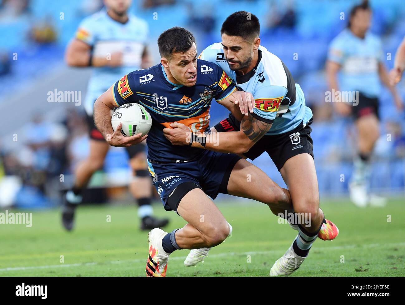 Corey Thompson of the Titans (left) Shaun Johnson of the Sharks is ...