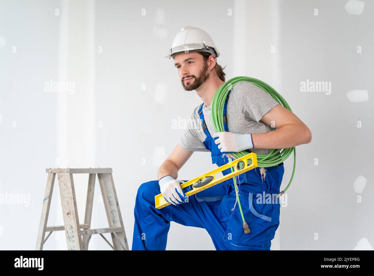 Portrait of male worker professional electrician in uniform installing ...