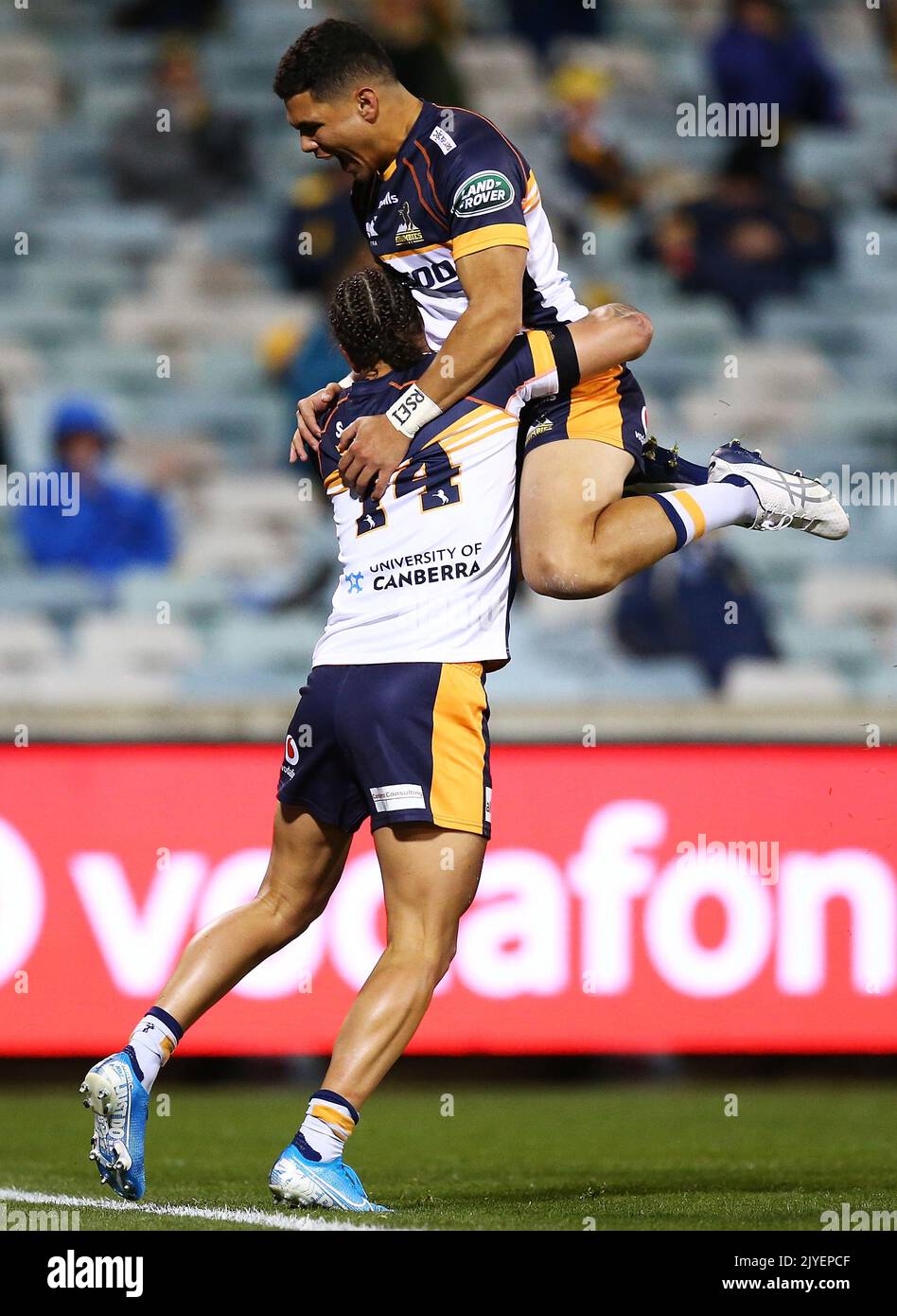 Andy Muirhead of the Brumbies celebrates his try with ten mates during ...