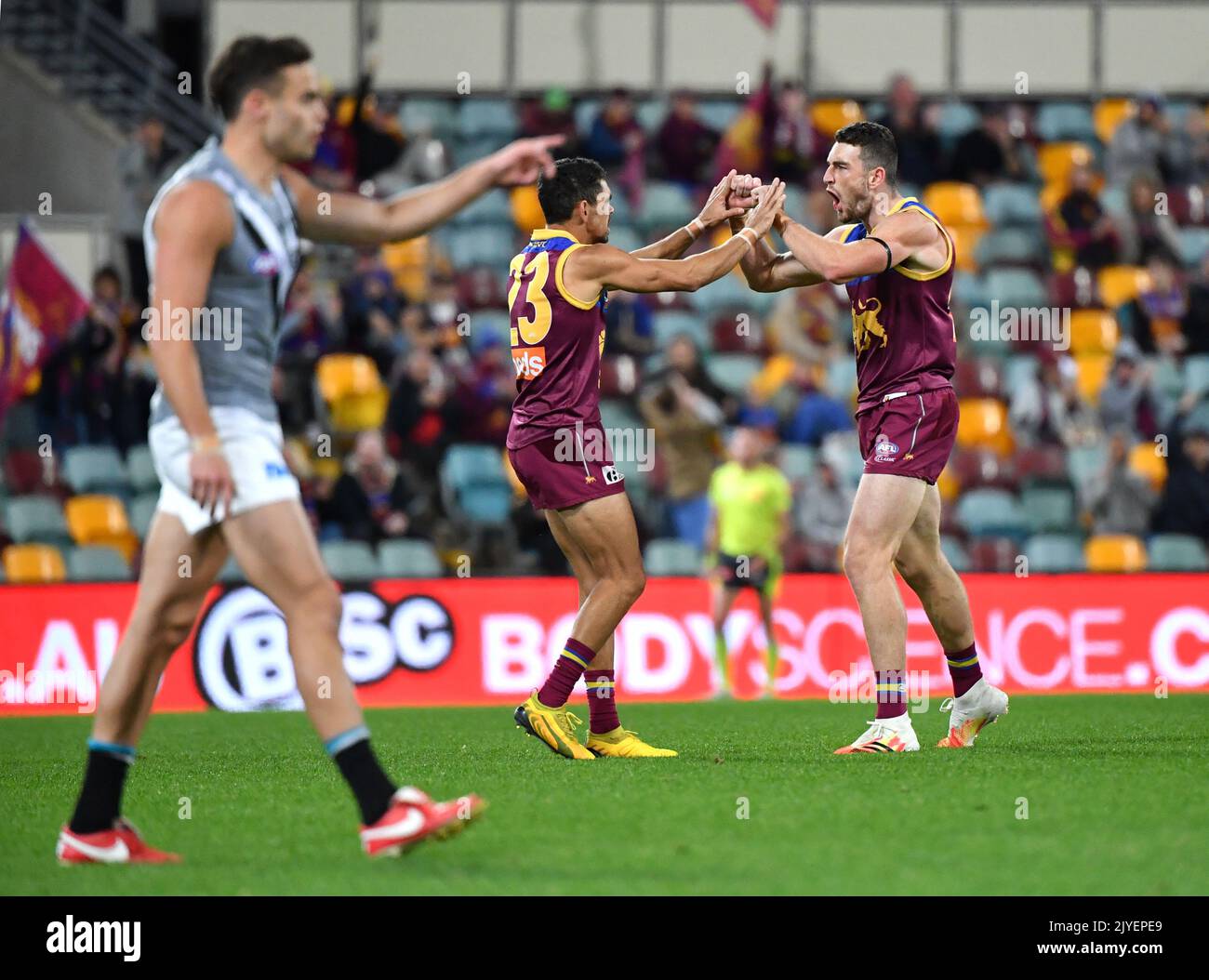 Daniel McStay (right) of the Lions celebrates kicking a goal with ...