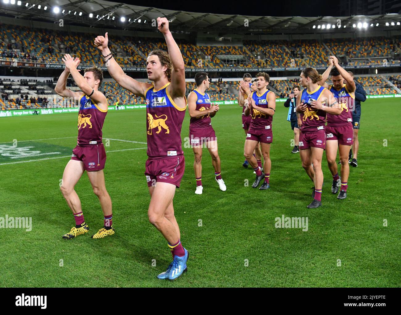 Jarrod Berry (2nd from left) of the Lions celebrates winning the Round ...