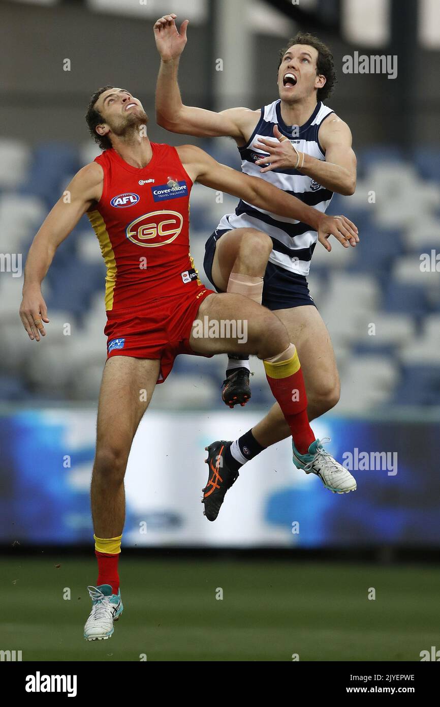 Jarrod Witts of the Suns and Darcy Fort of the Cats compete for the ...