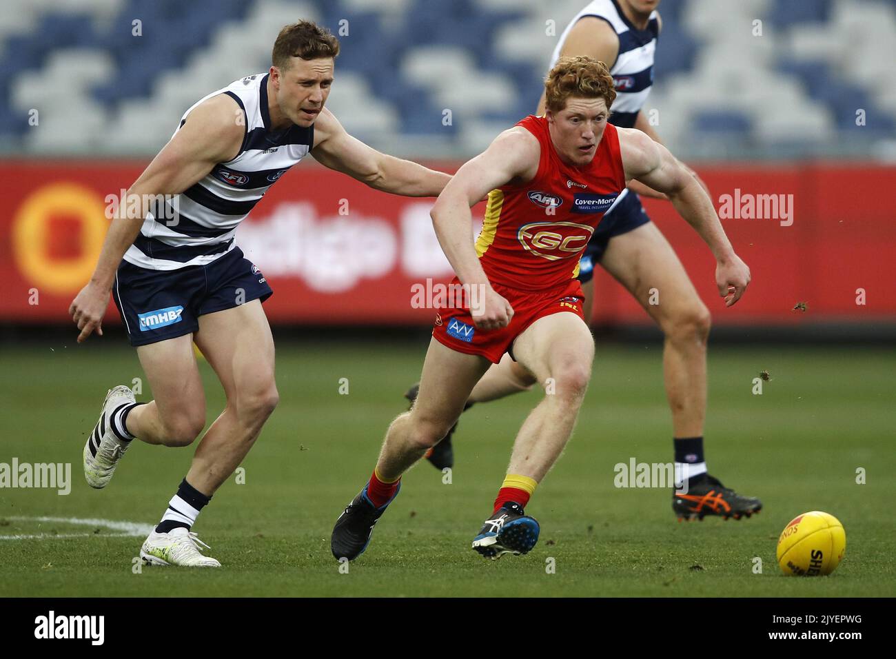 Matthew Rowell of the Suns and Mitch Duncan of the Cats compete for the ...