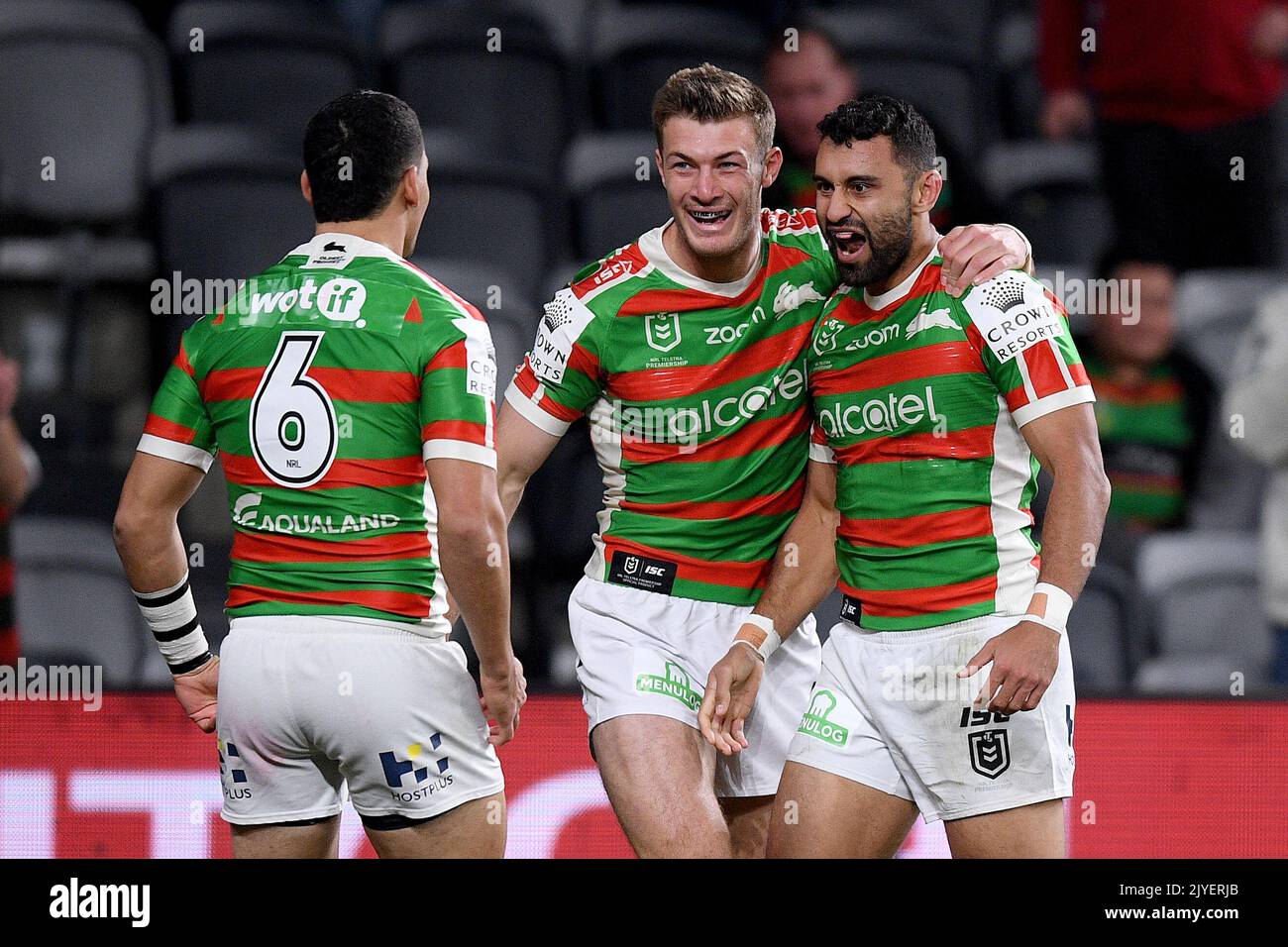 Alex Johnston of the Rabbitohs (right) celebrates with teammates after ...