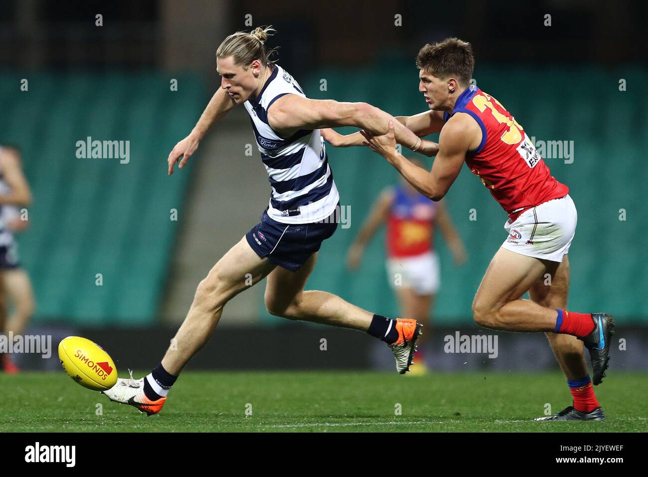 Mark Blicavs of the Cats contests the ball with Zac Bailey of the Lions ...