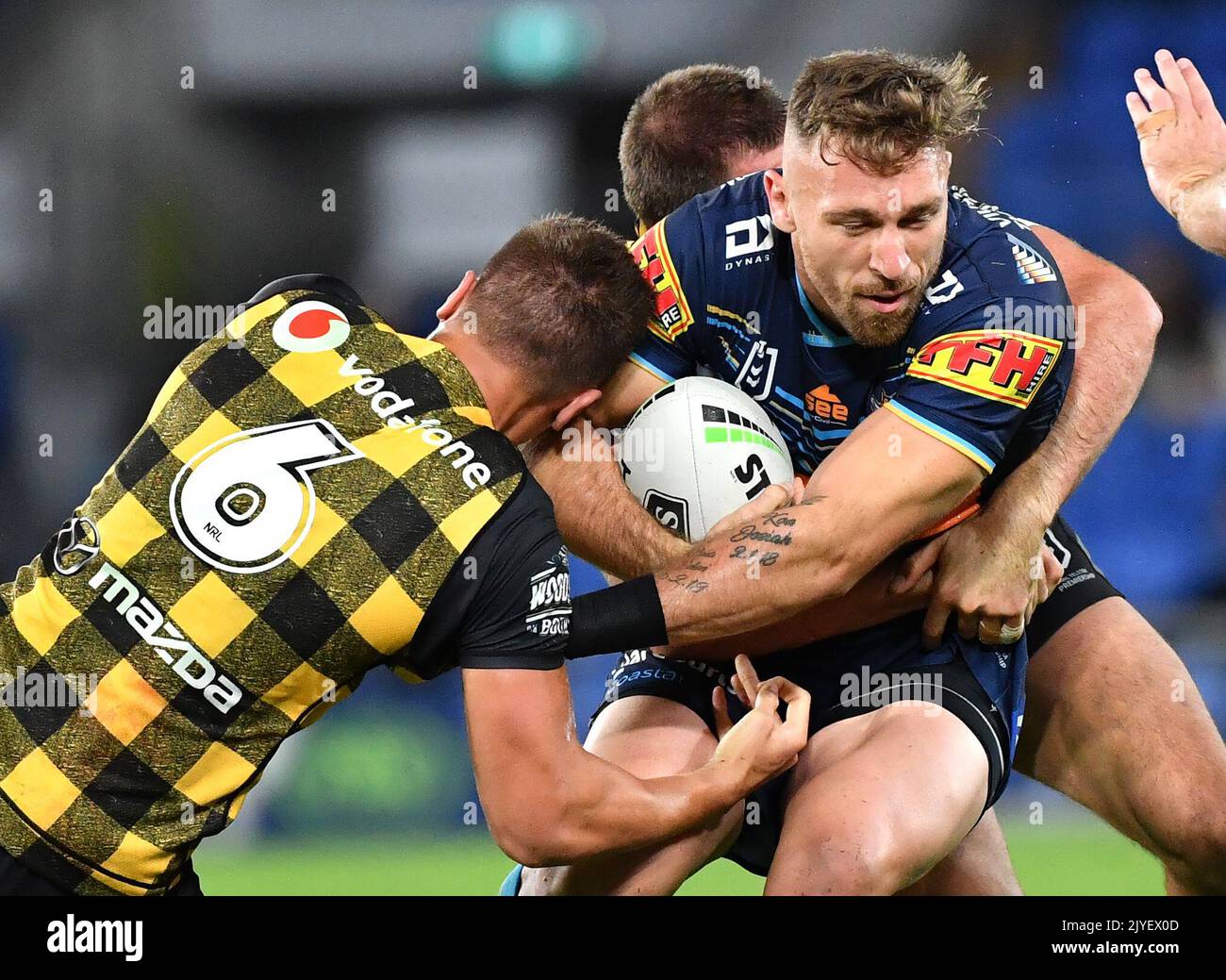 Bryce Cartwright (right) of the Titans is tackled by Chanel Harris ...
