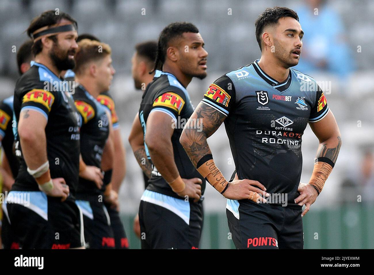 Briton Nikora of the Sharks (right) and teammates look on after ...