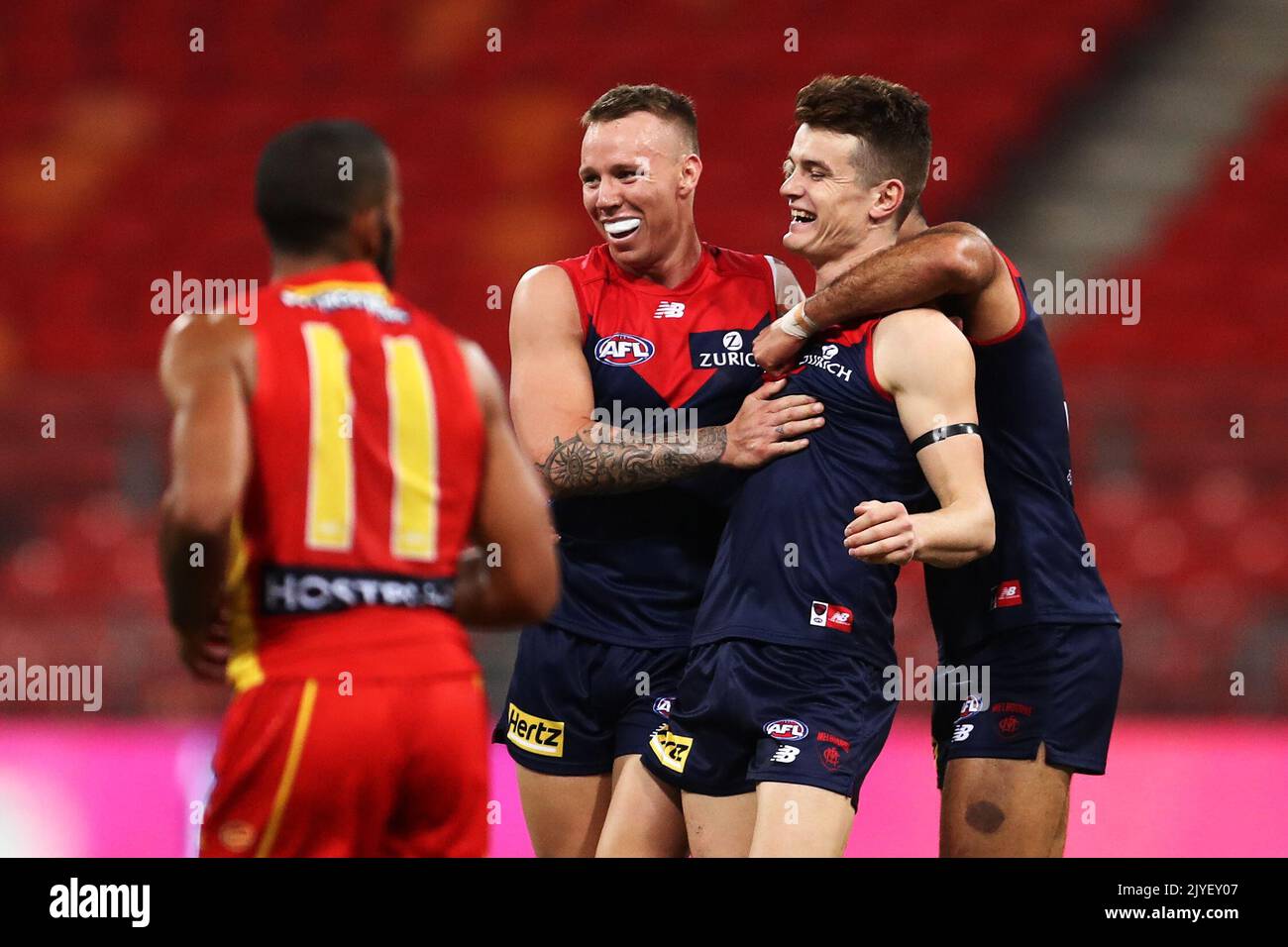 Bayley Fritsch of the Demons celebrates kicking a goal with team mates ...