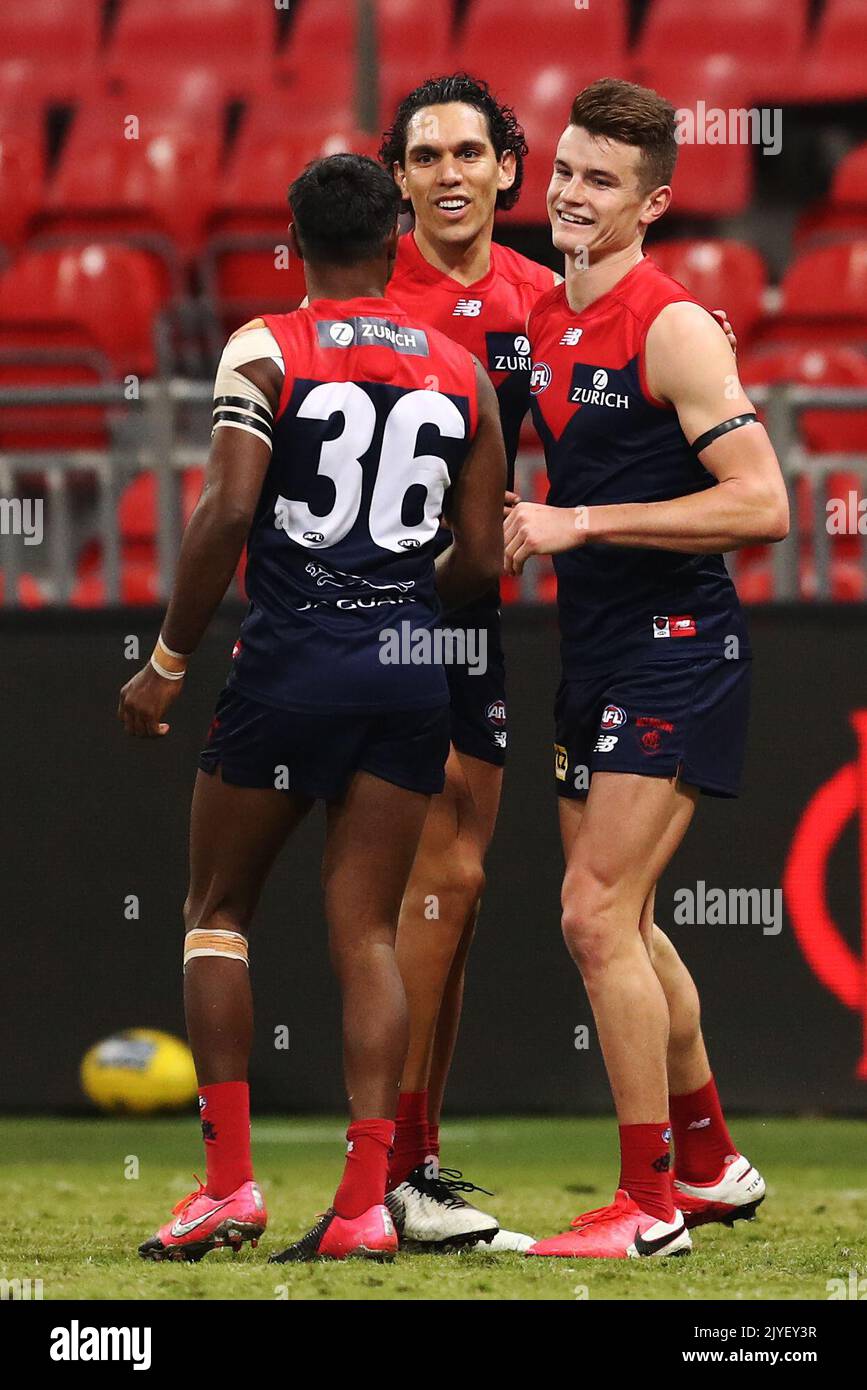Bayley Fritsch of the Demons celebrates kicking a goal with team mates ...