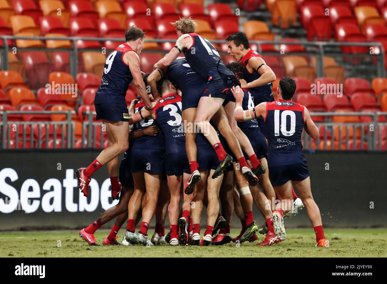 Demons celebrate victory over the Suns during the Round 6 AFL match ...
