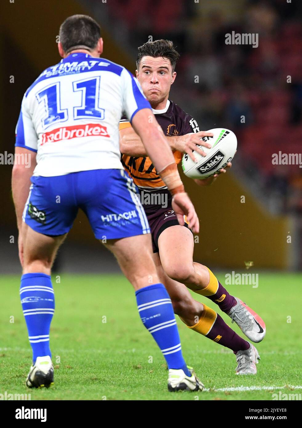 Brodie Croft of the Broncos (right) comes against Josh Jackson of the ...