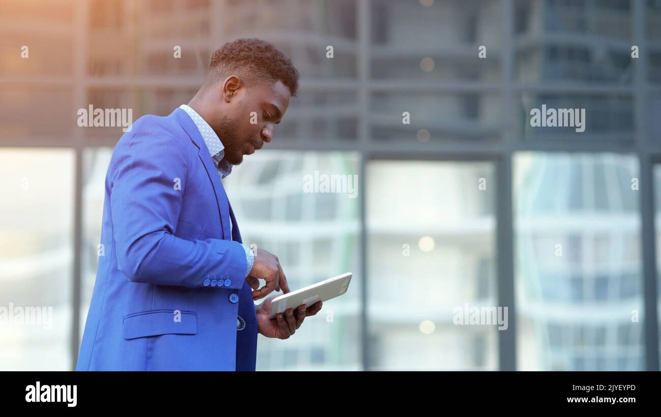 African american businessman walk tablet hi-res stock photography and ...