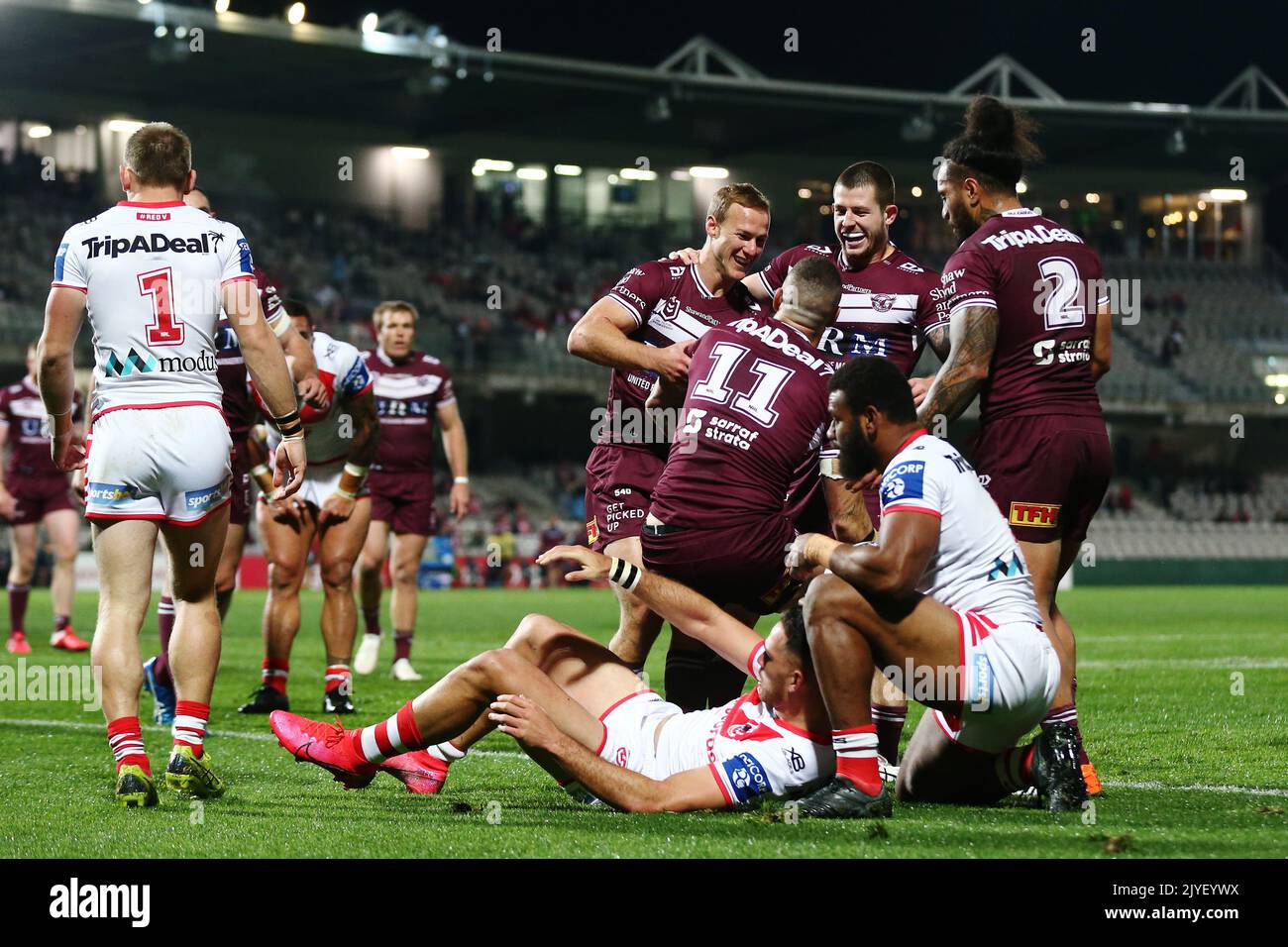 Joel Thompson of the Sea Eagles celebrates scoring a try with team ...