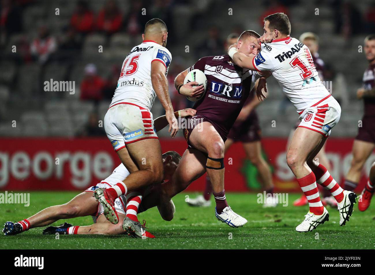 Sean Keppie of the Sea Eagles is tackled by the Dragons defence during ...