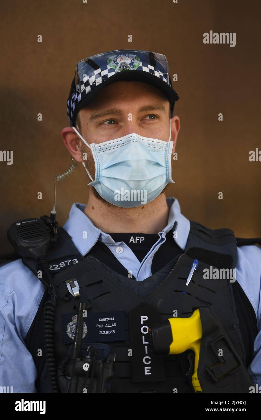 An ACT Police officer wears a face mask during a demonstrations of ...