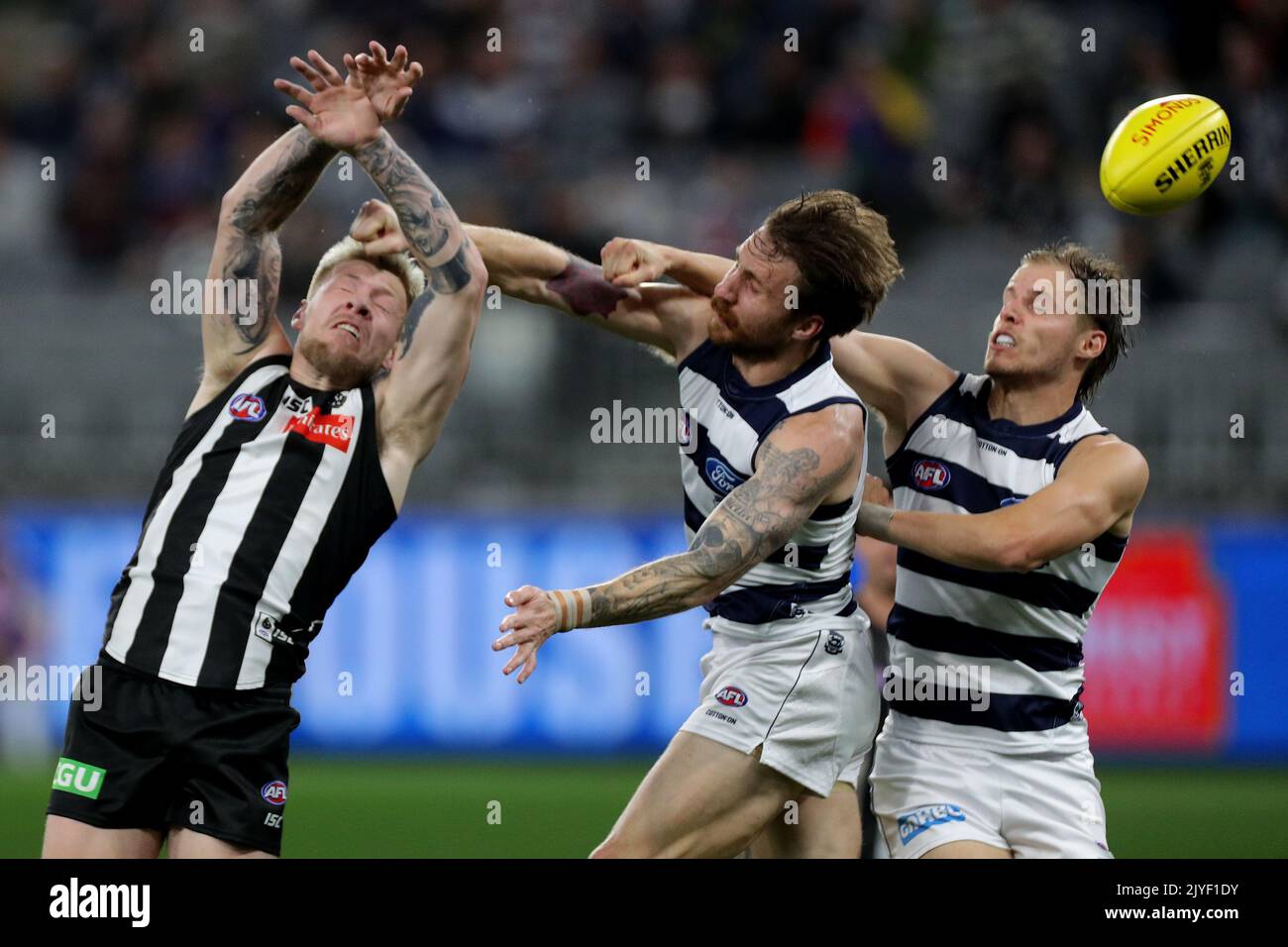 Jordan de Goey of the Magpies and Zach Tuohy of the Cats compete for ...
