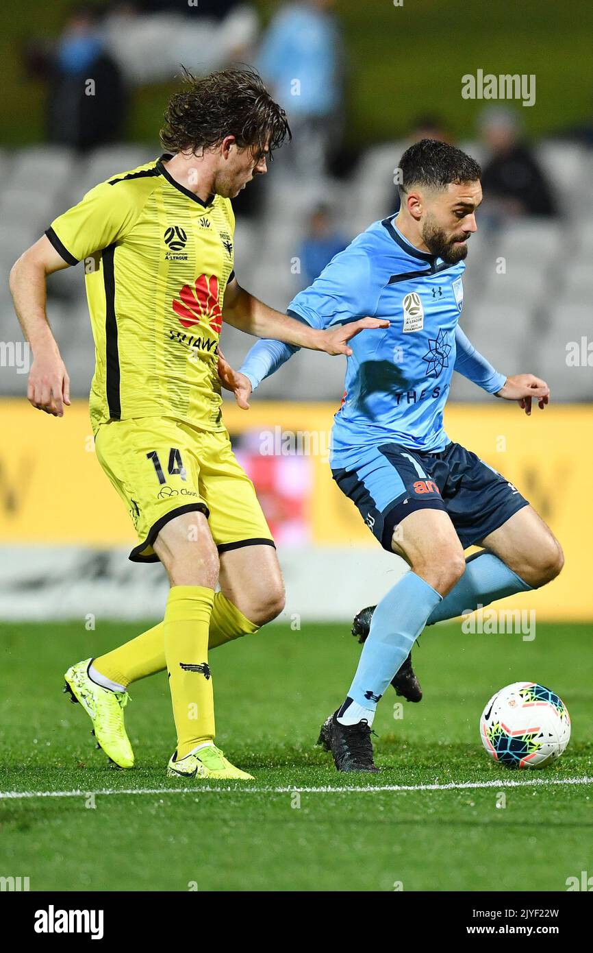 Anthony Caceres of Sydney comes under pressure form Alex Rufer of the ...