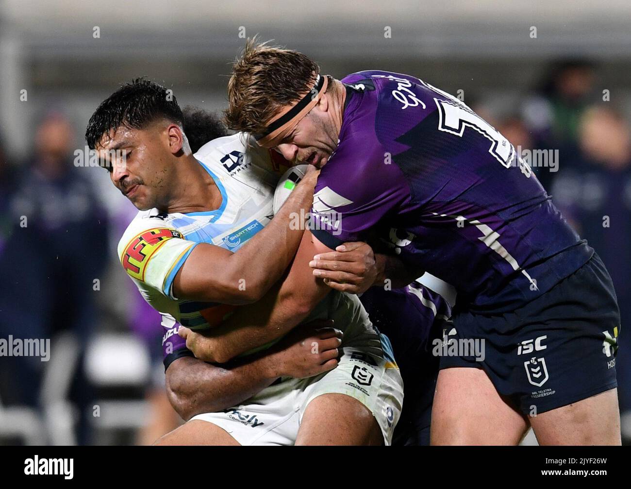 Tyrone Peachey of the Titans (left) is held back by Christian Welch of ...