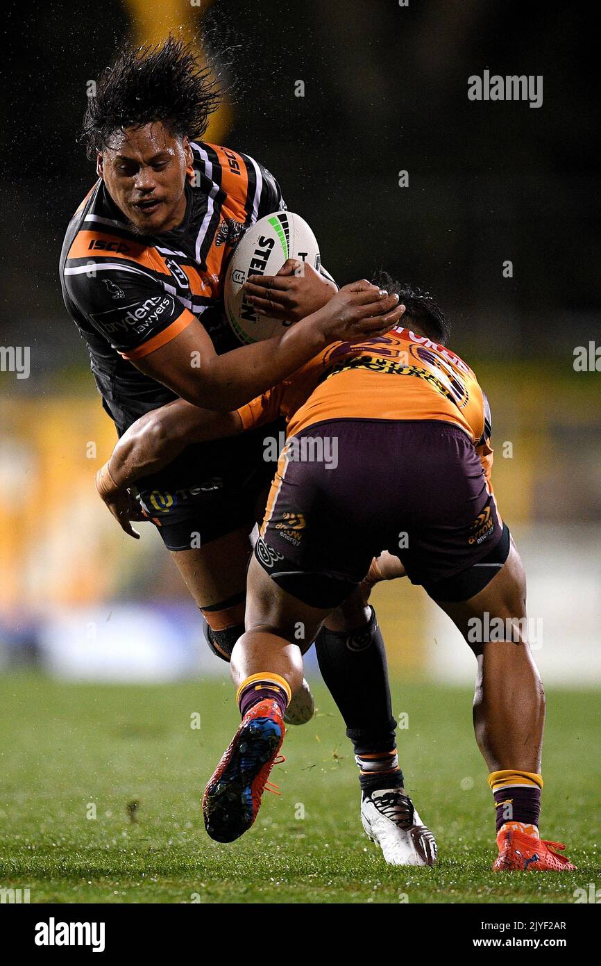 Luciano Leilua of the Tigers is tackled by Richard Kenner of the ...