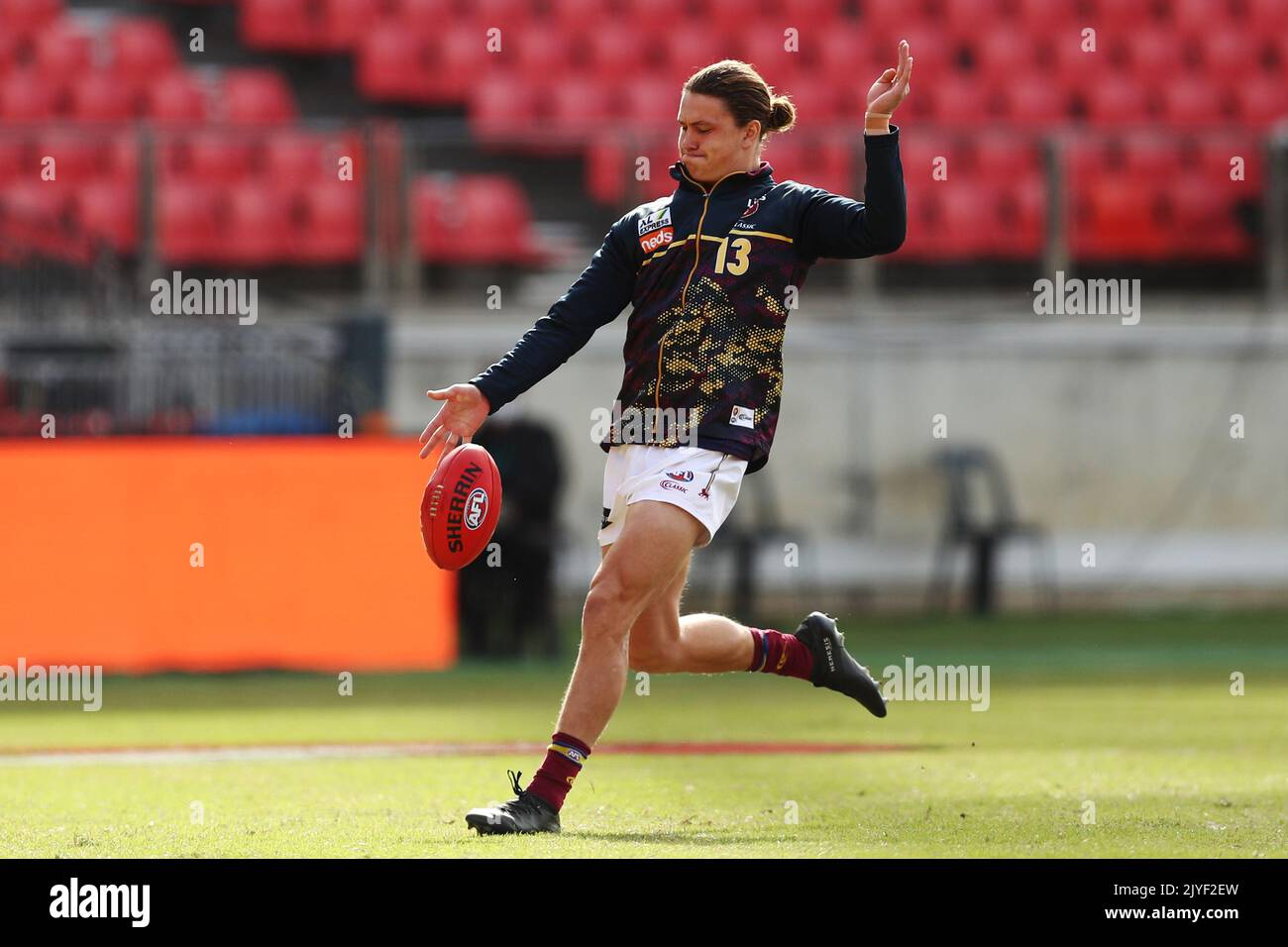 Thomas Berry of the Lions warms up ahead of the Round 7 AFL match ...