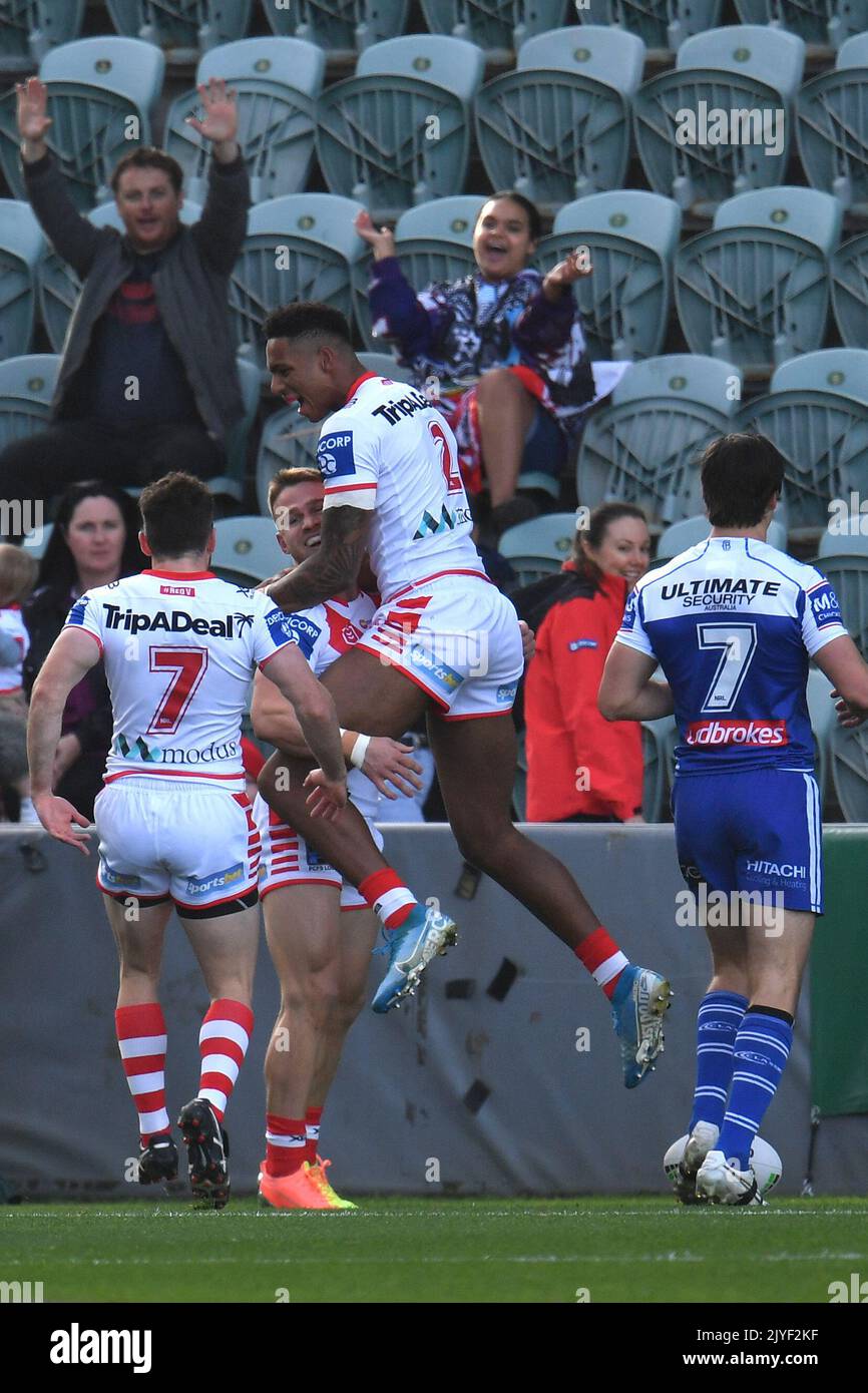 Euan Aitken of the Dragons celebrates his try with Jason Saab and Adam ...