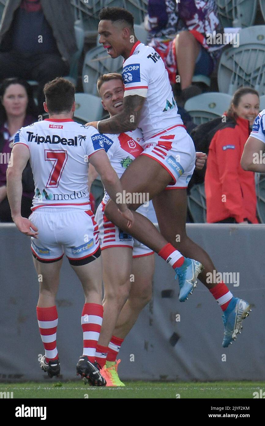 Euan Aitken of the Dragons celebrates his try with Jason Saab and Adam ...