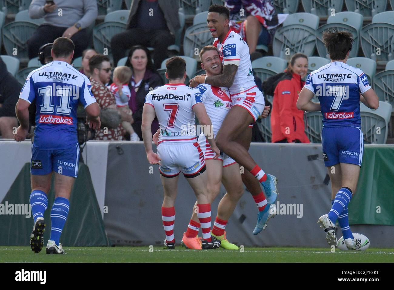 Euan Aitken of the Dragons celebrates his try with Jason Saab and Adam ...