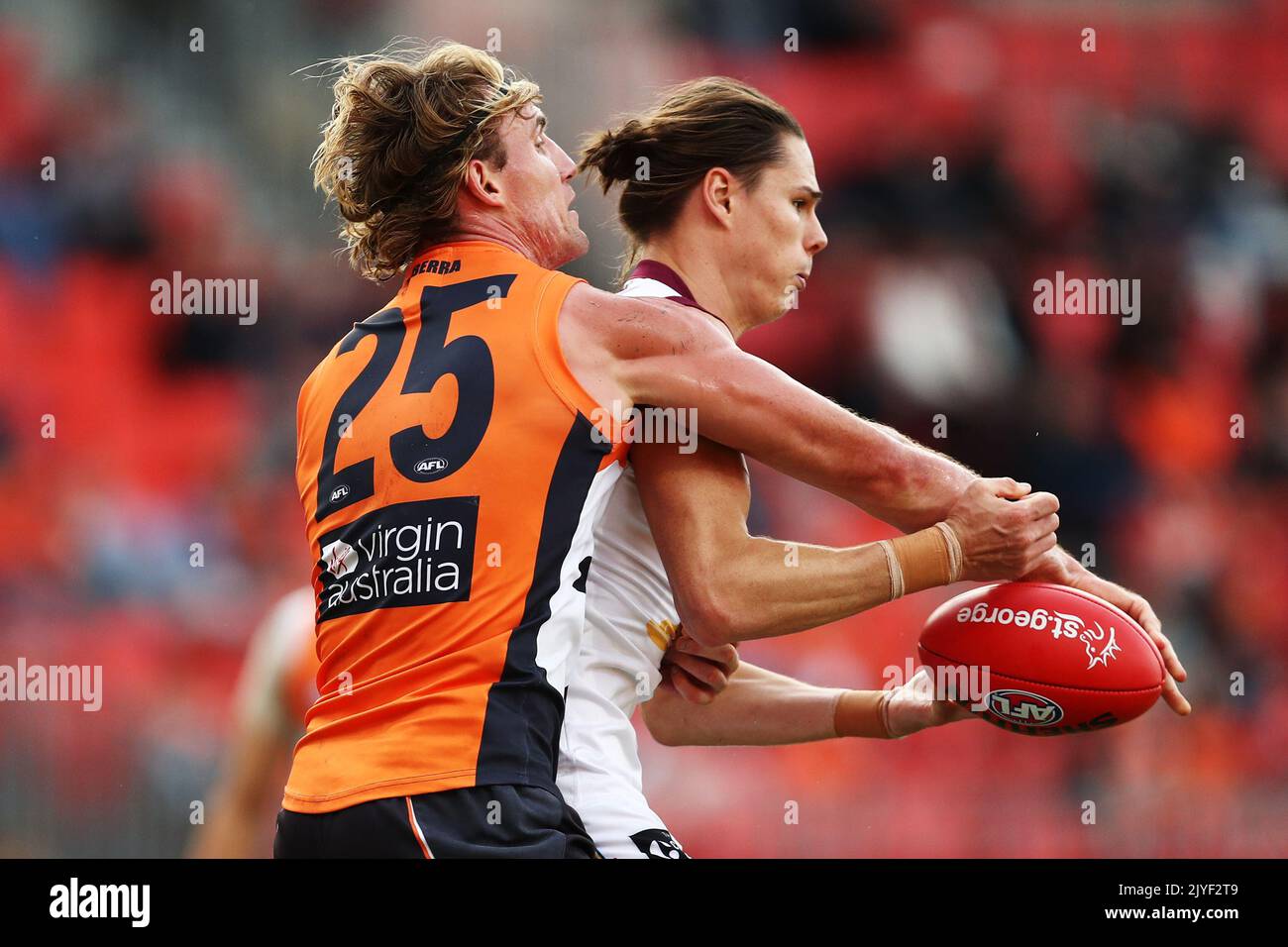 Eric Hipwood of the Lions contests the ball with Lachlan Keeffe of the ...