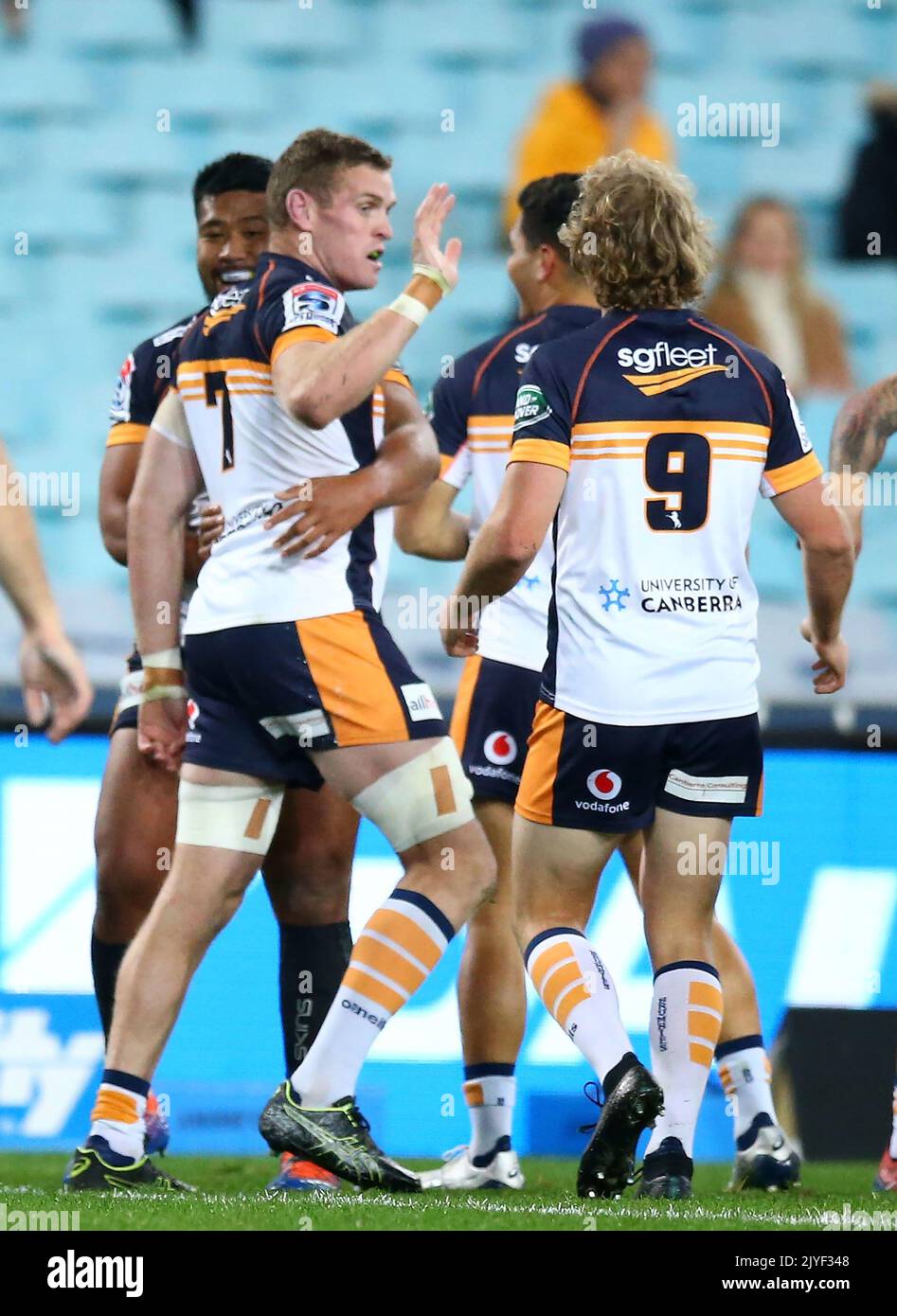 Tom Cusack of the Brumbies celebrates with team mates after scoring ...