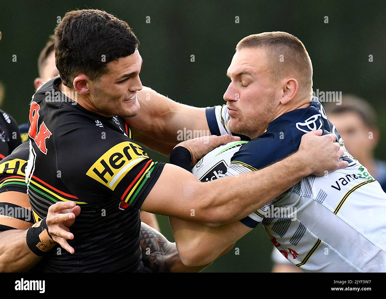 Nathan Cleary of the Panthers tackles Kyle Feldt of the Cowboys (right ...