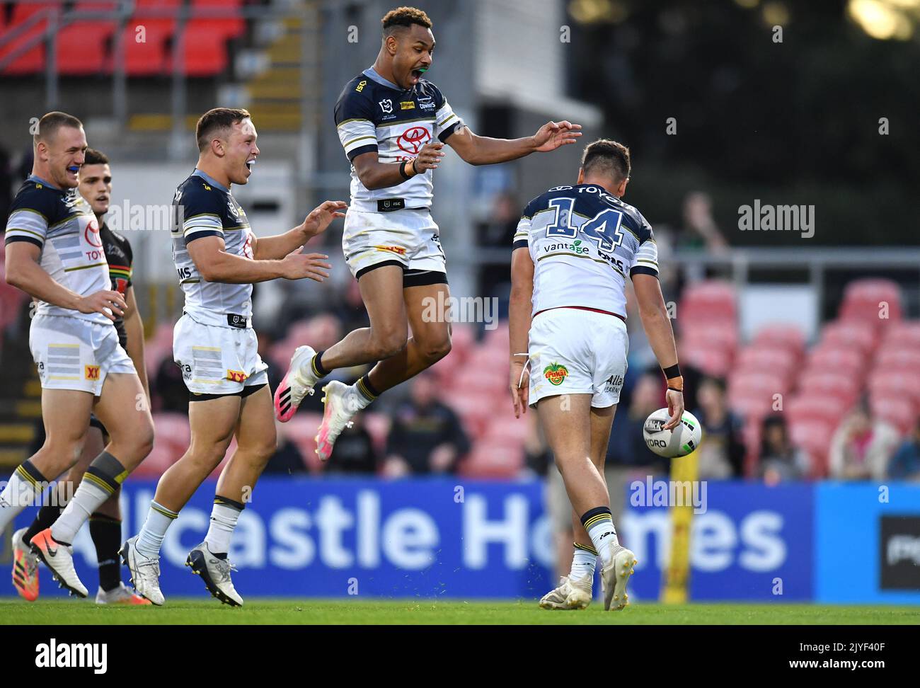 Hamiso Tabuai-Fidow of the Cowboys (centre) reacts with try scorer ...