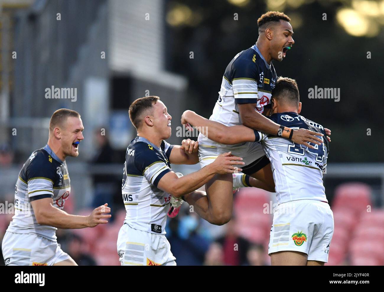 Hamiso Tabuai-Fidow of the Cowboys with try scorer Daejarn Asi (right ...