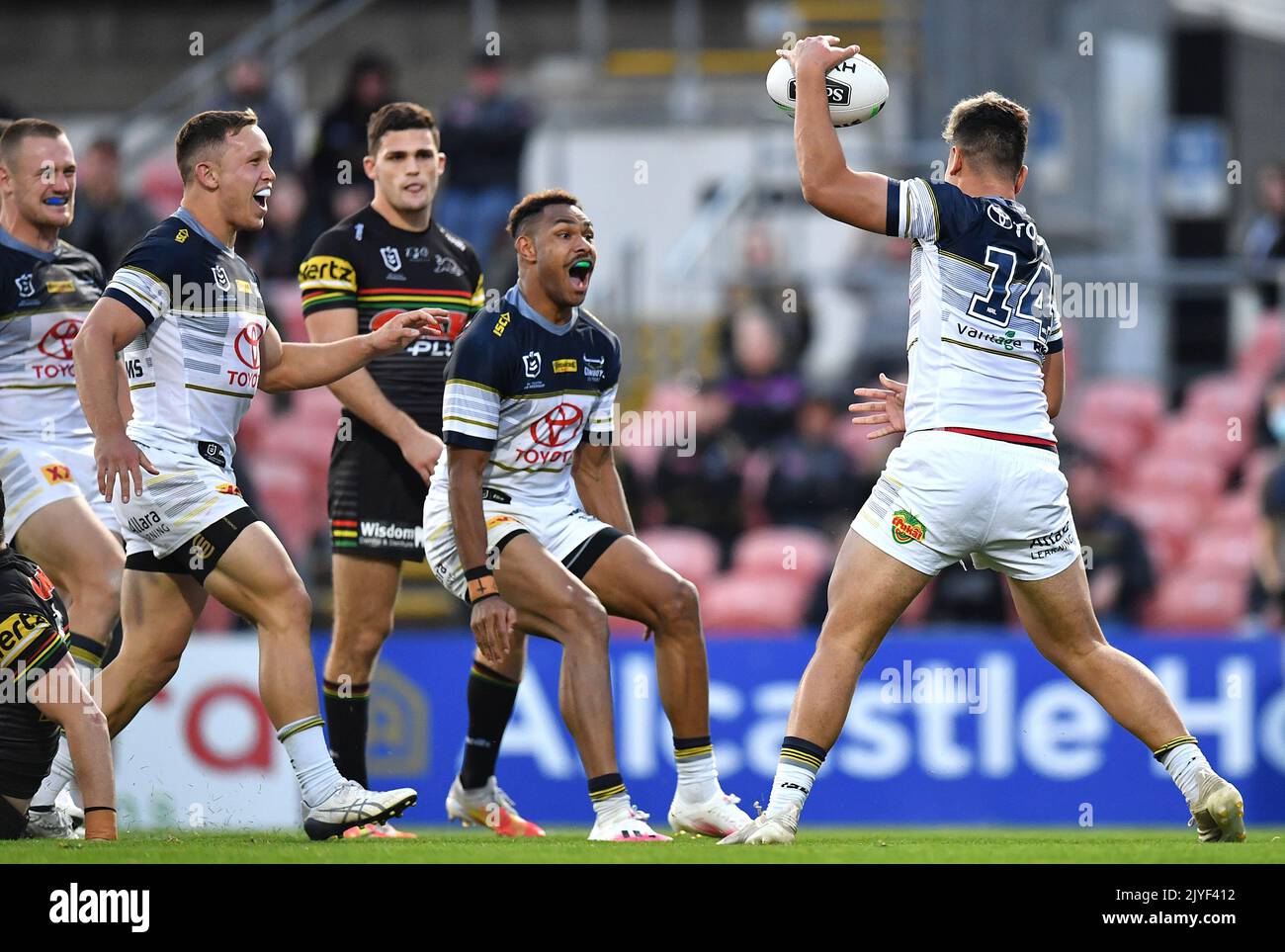 Cowboys players reacts with Daejarn Asi (right) after he scored a try ...