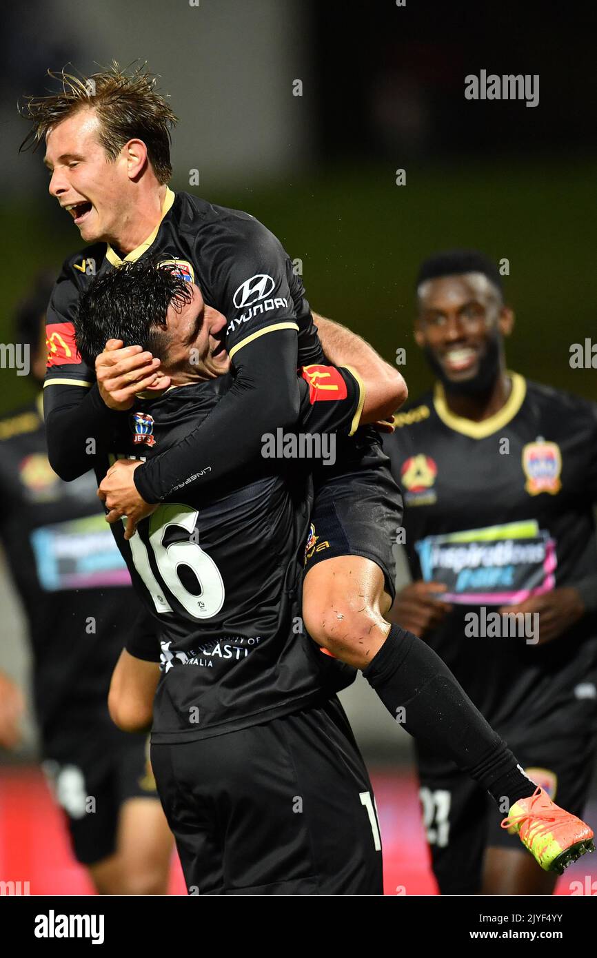 Nick Fitzgerald leaps on Matthew Millar in celebration after scoring ...
