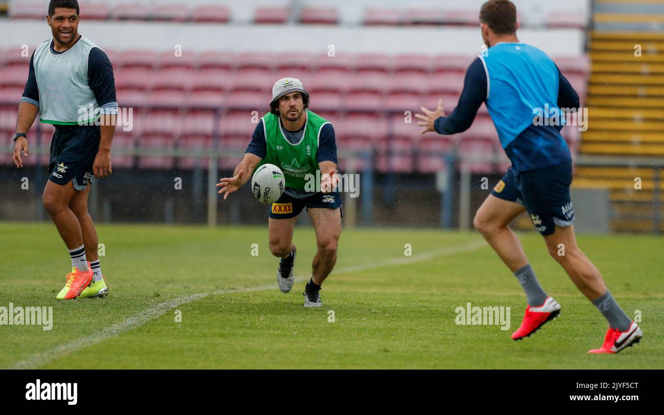 Jake Granville passes to Gavin Cooper during an NRL North Queensland ...