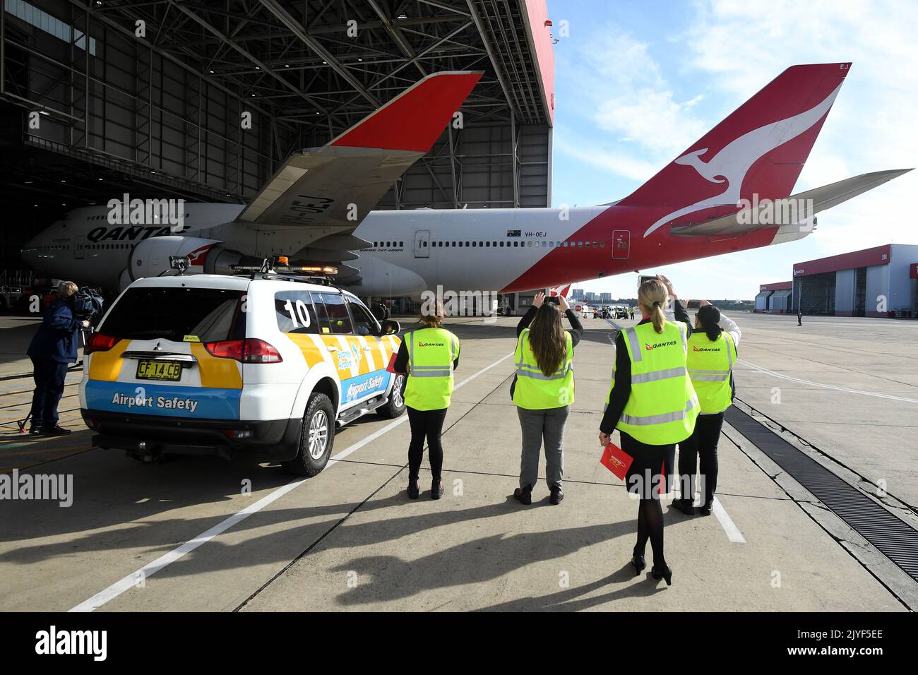 Staff photograph Qantas Airways flight QF7474 as it leaves Hanger 96 ...