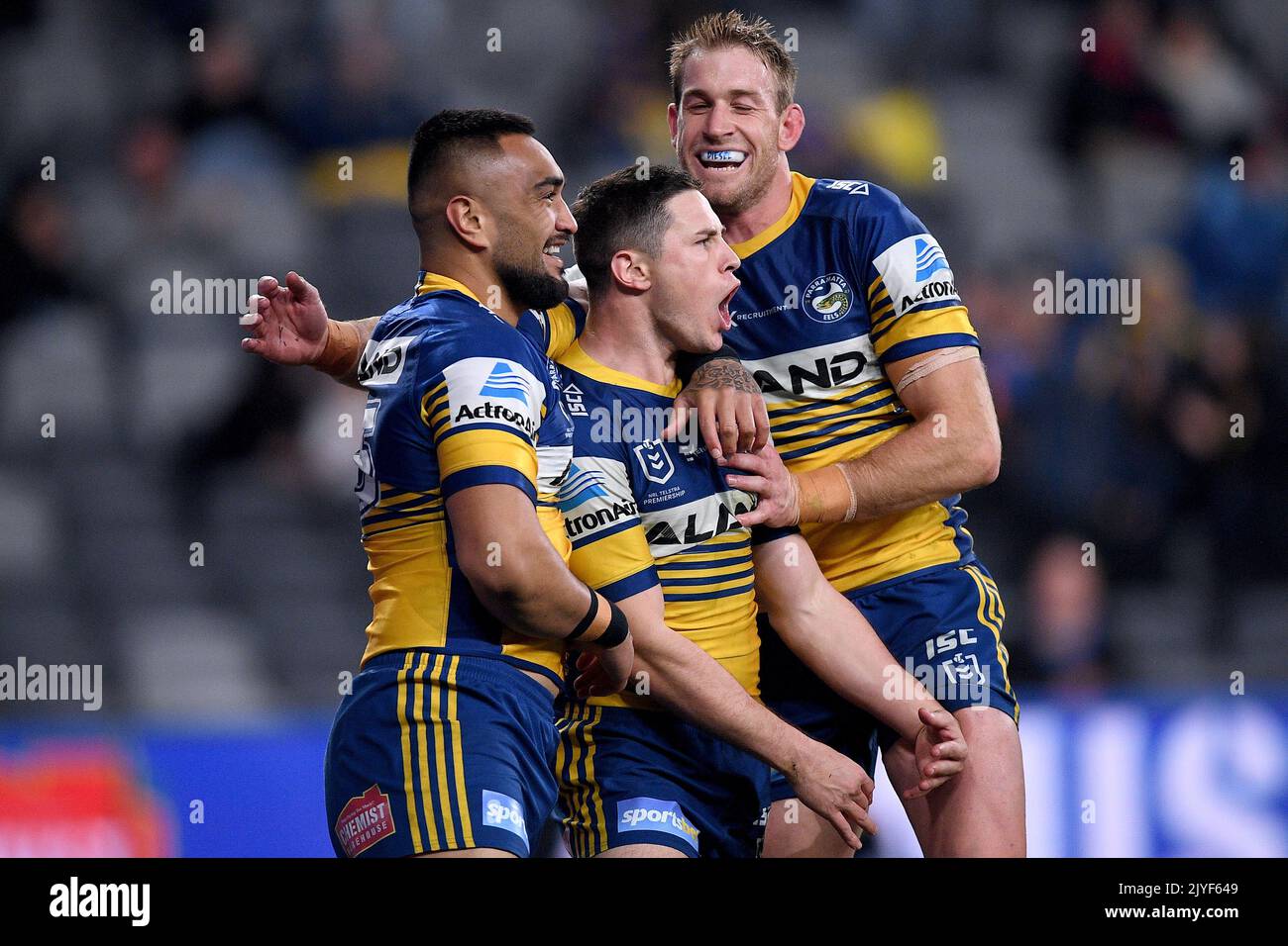 Mitchell Moses of the Eels (centre) celebrates with teammates after ...