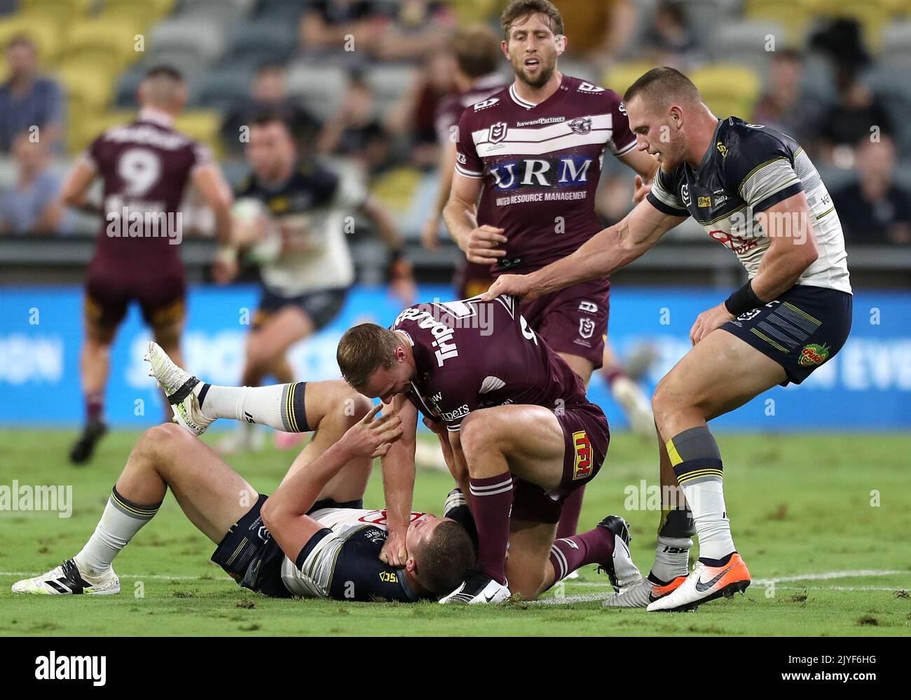 Cowboys player Coen Hess (right) pulls at Daly Cherry-Evans of the Sea ...