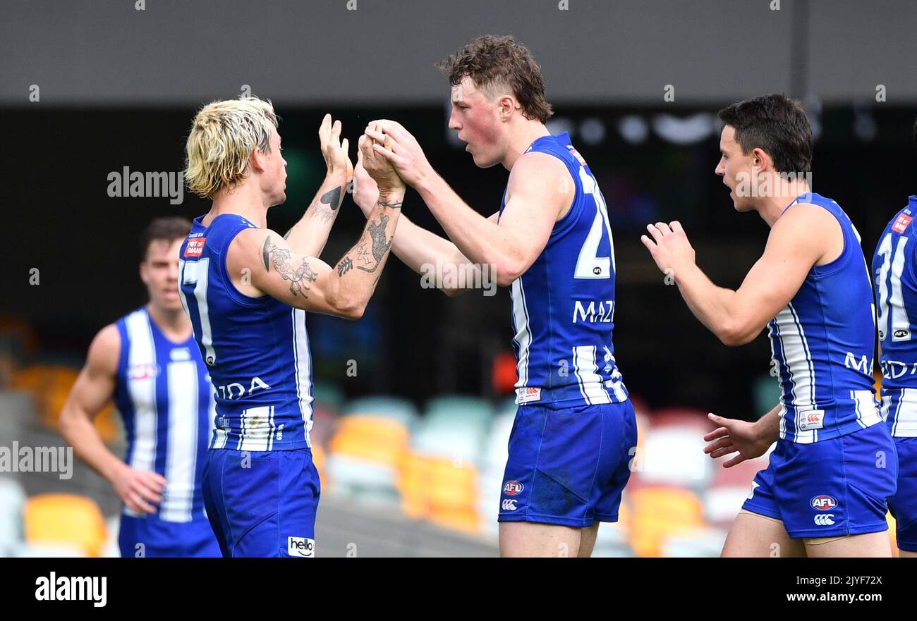 Nick Larkey (centre) of the Kangaroos celebrates kicking a goal with ...
