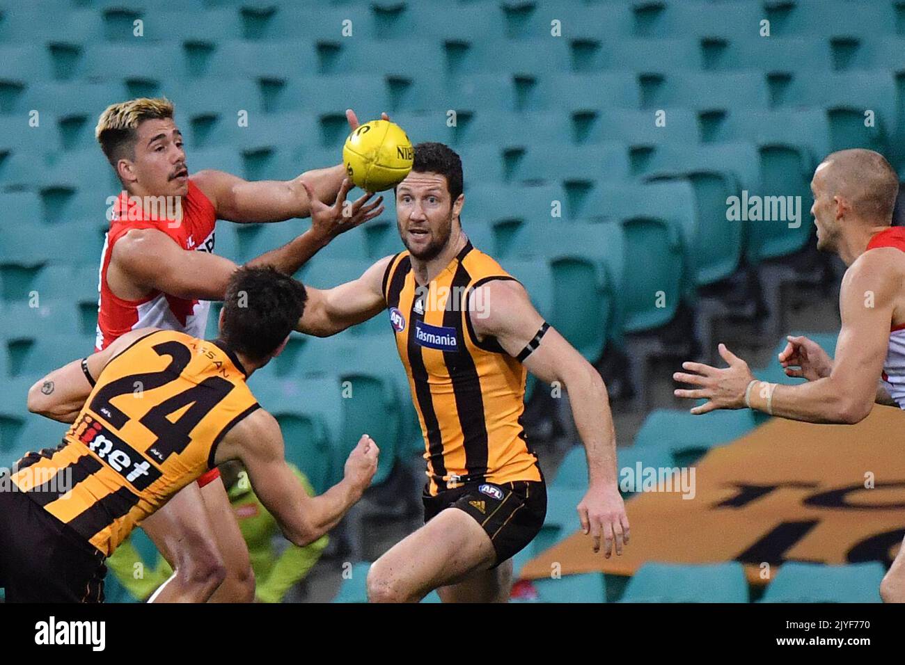 Elijah Taylor of the Swans comes under pressure from Ben Stratton of ...