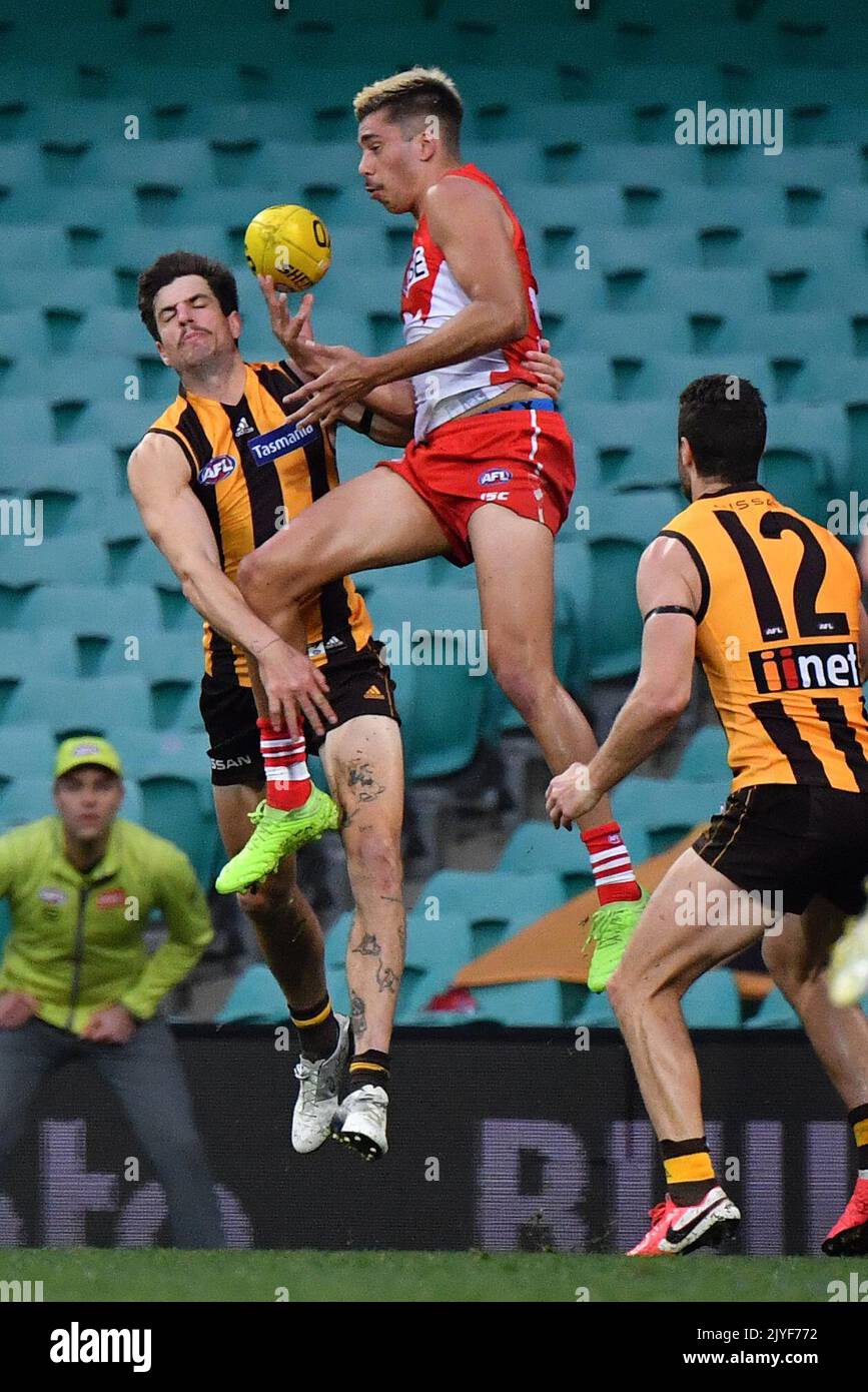 Elijah Taylor of the Swans comes under pressure from Ben Stratton of ...