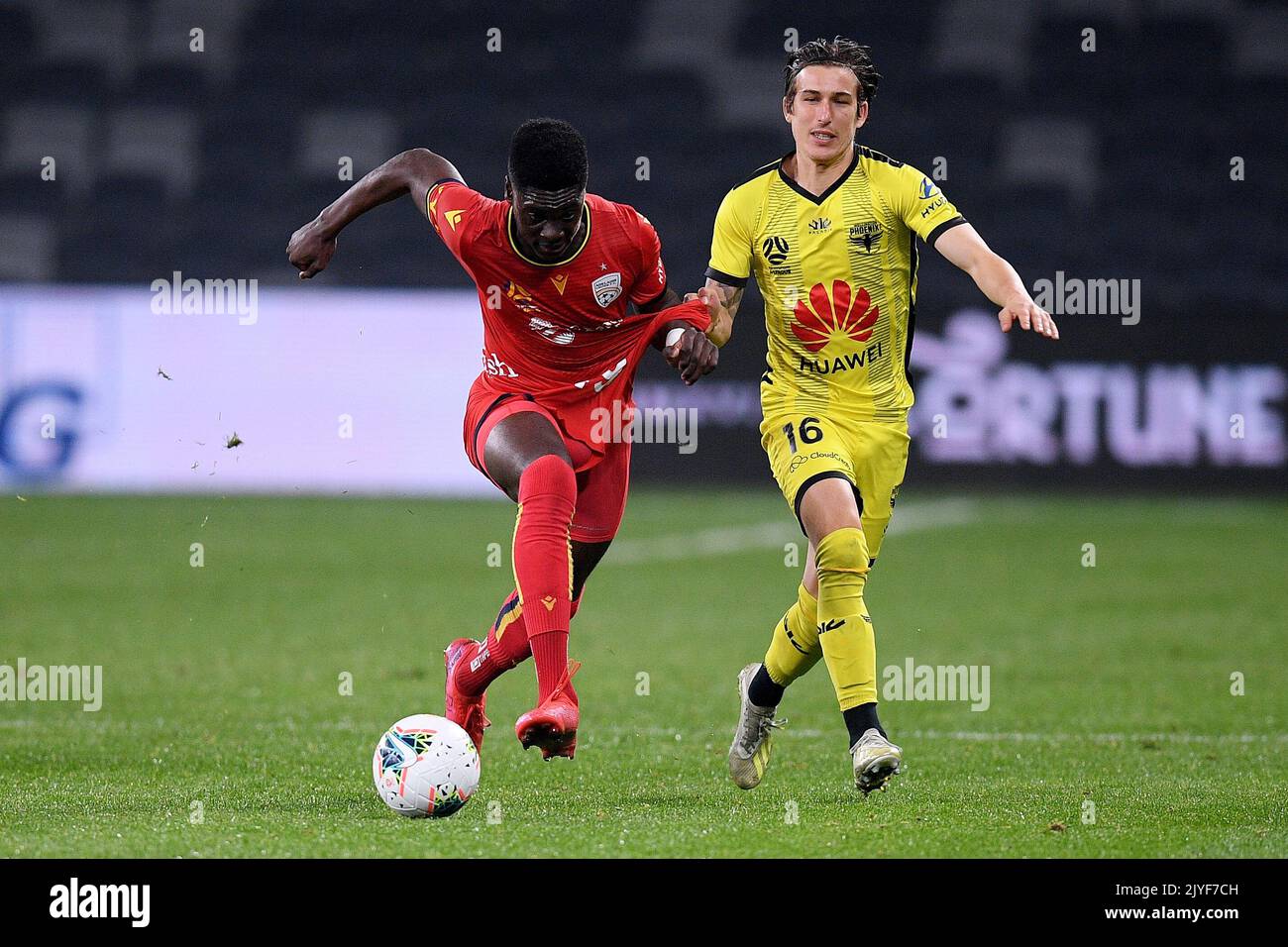Mohamed Toure of United competes for possession with Louis Fenton of ...