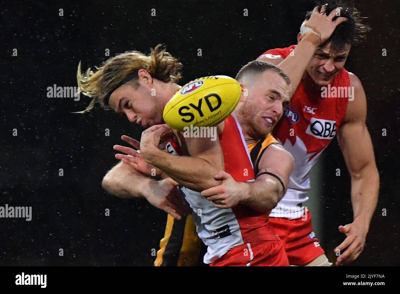 James Rowbottom of the Swans is tackled by Tom Mitchell of the Hawks ...