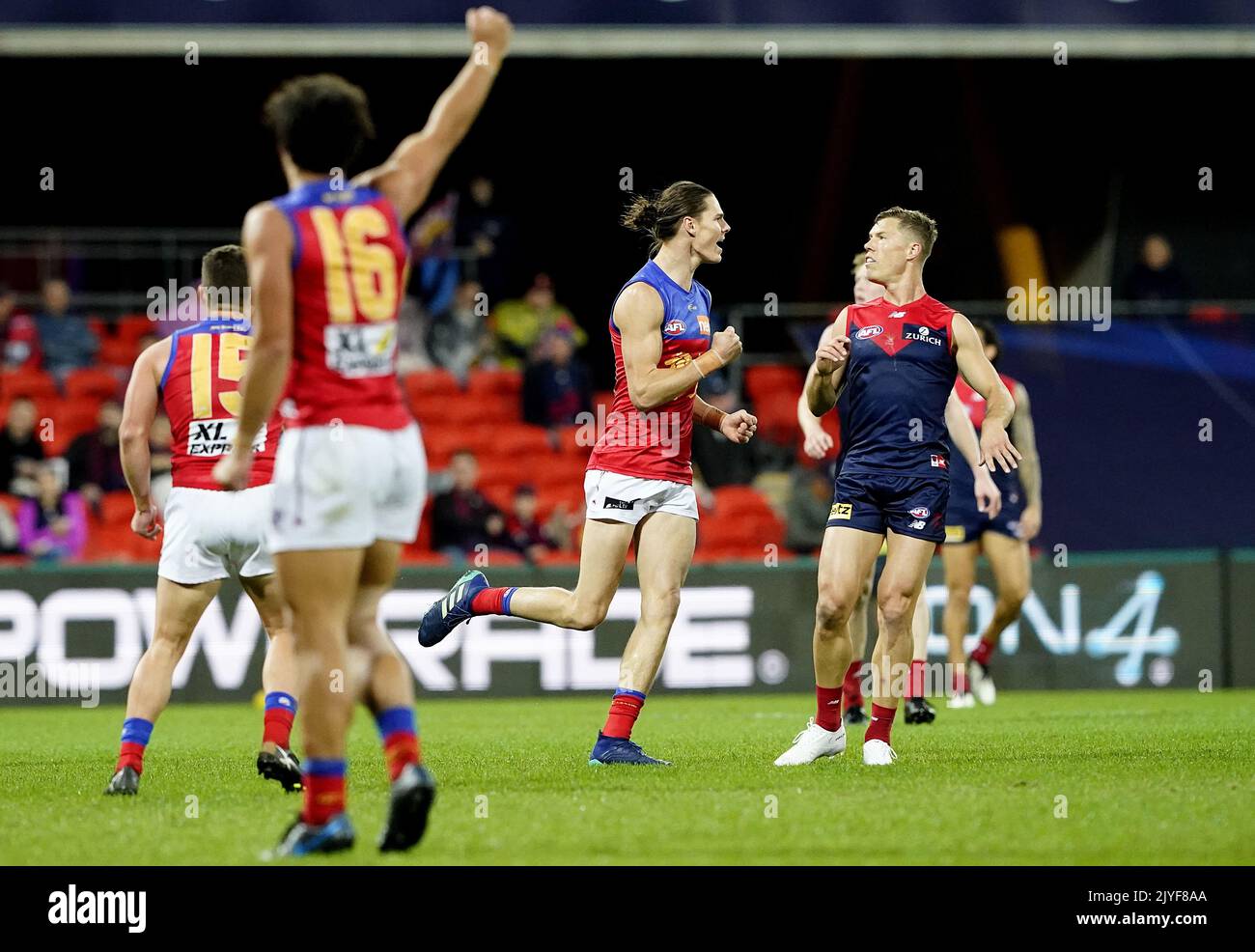 Eric Hipwood of the Lions (right) celebrates after kicking a goal ...