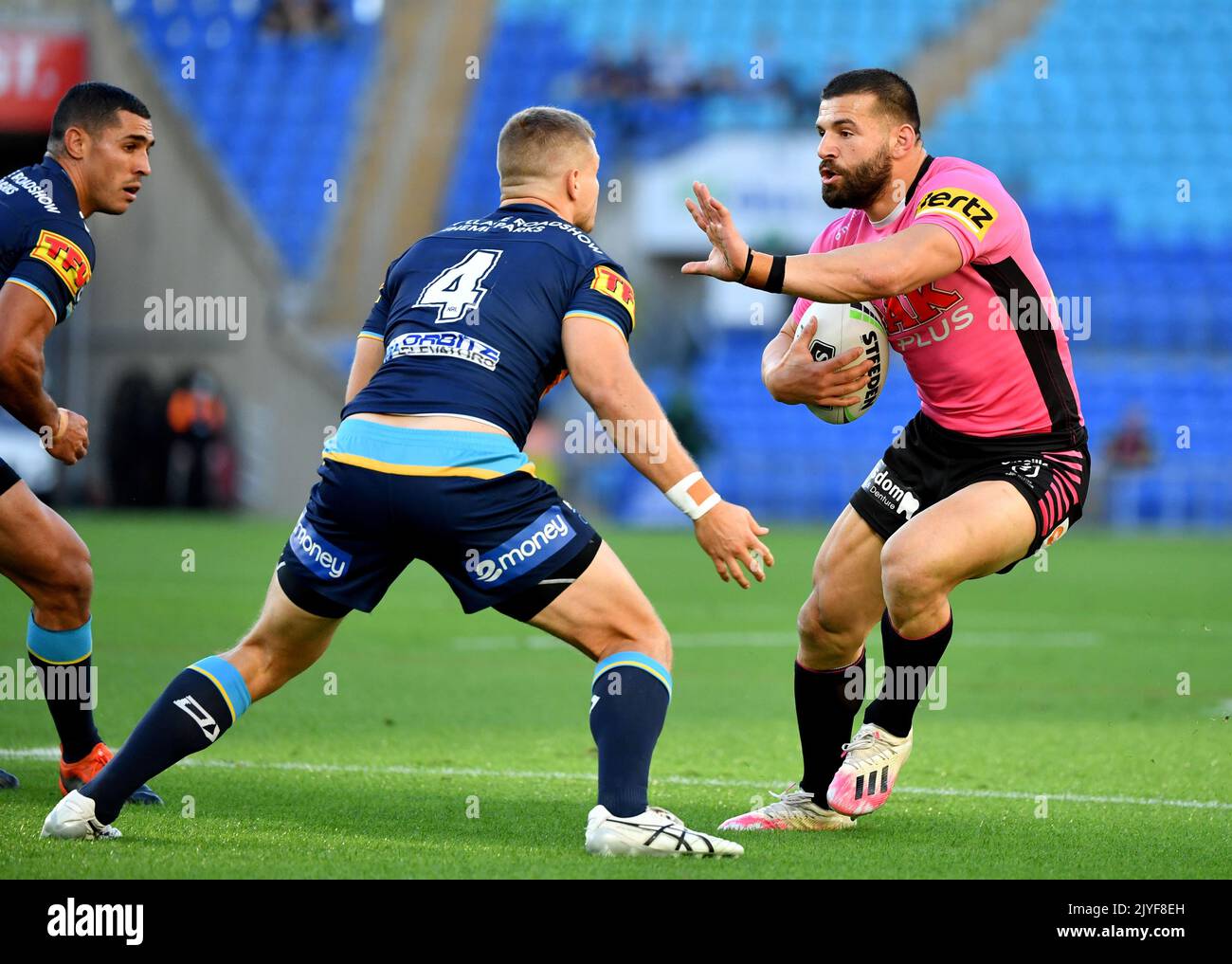 Josh Mansour (right) of the Panthers palms off Dale Copley (centre) of ...