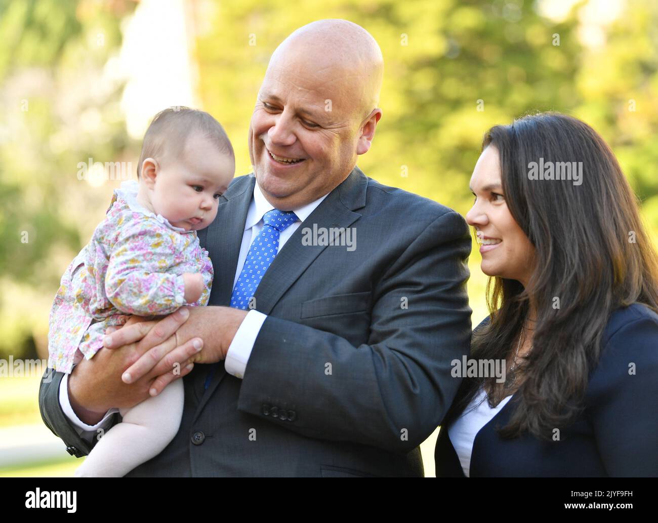 Liberal MP David Basham holds daughter Adelaide as wife Kate looks on ...