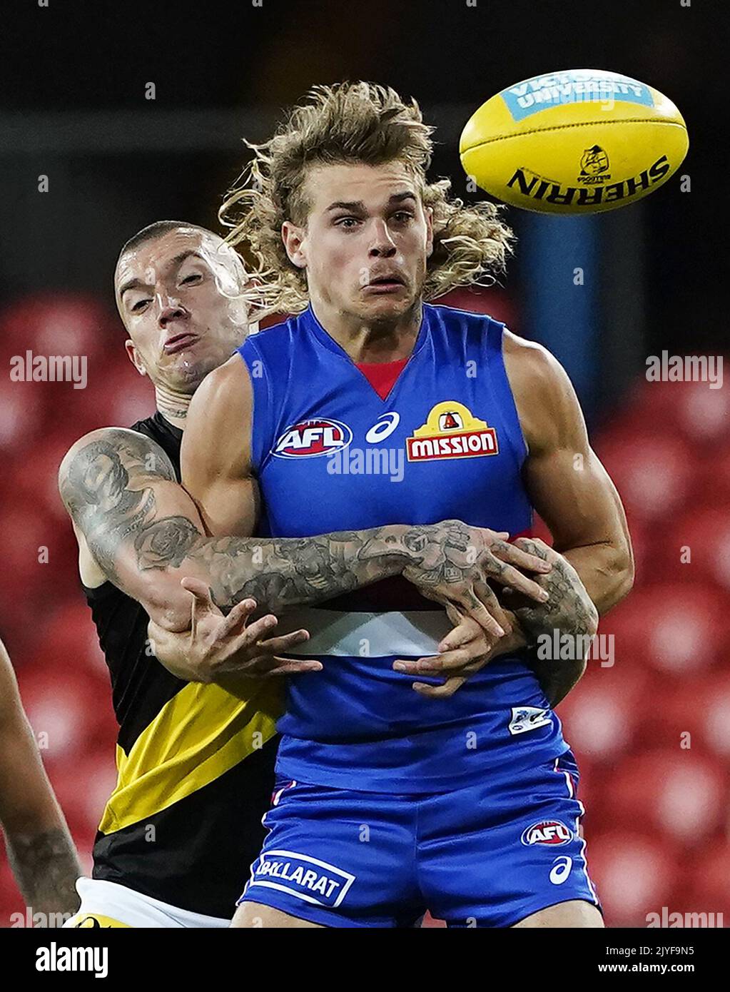 Dustin Martin of the Tigers (left) tackles Bailey Smith of the Bulldogs ...